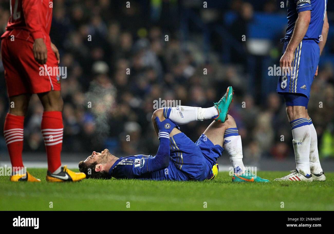 Chelsea's Juan Mata, center, reacts to his injury during their English ...