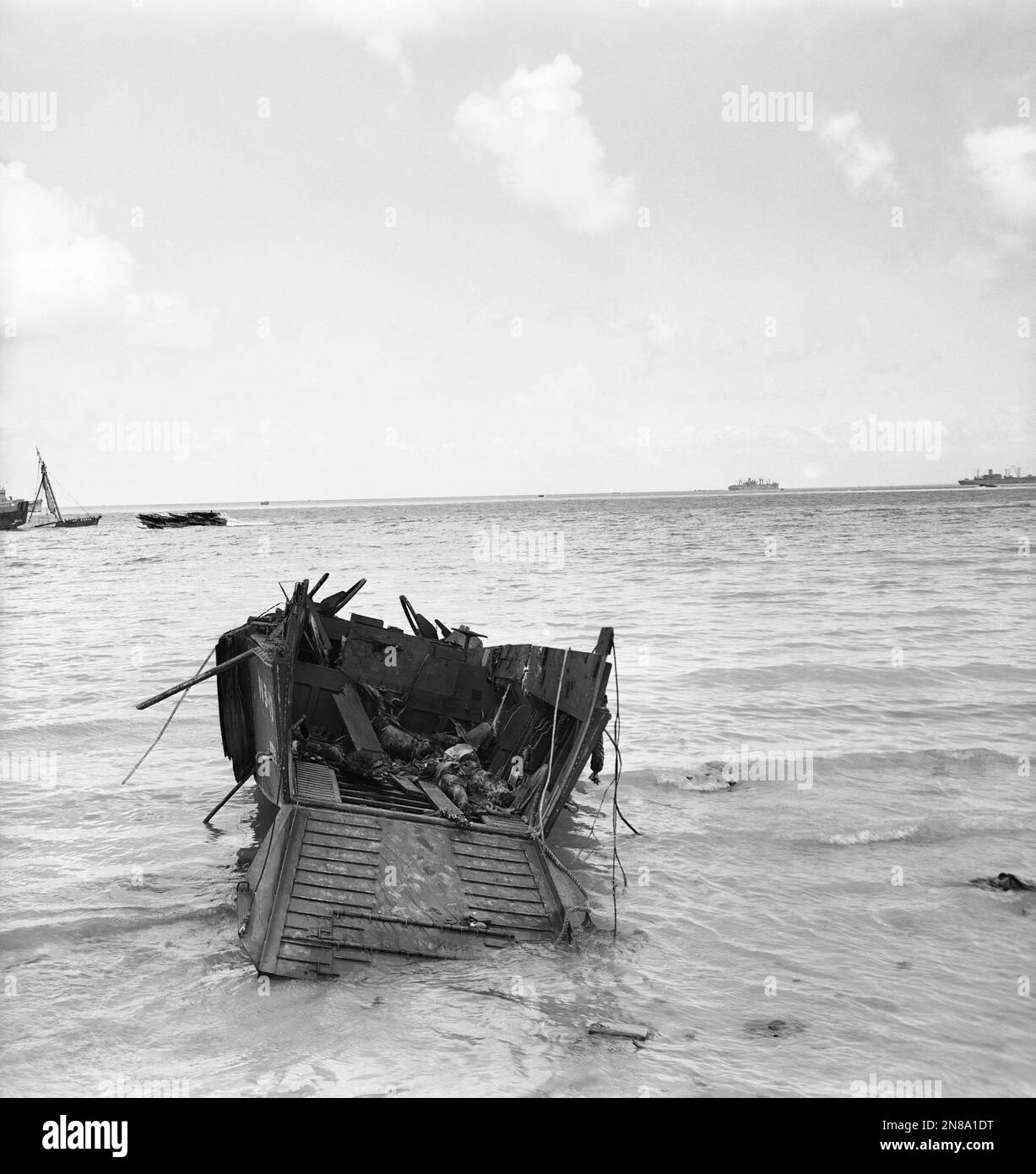 Dead Japanese soldiers can be seen in the shattered barge where they ...