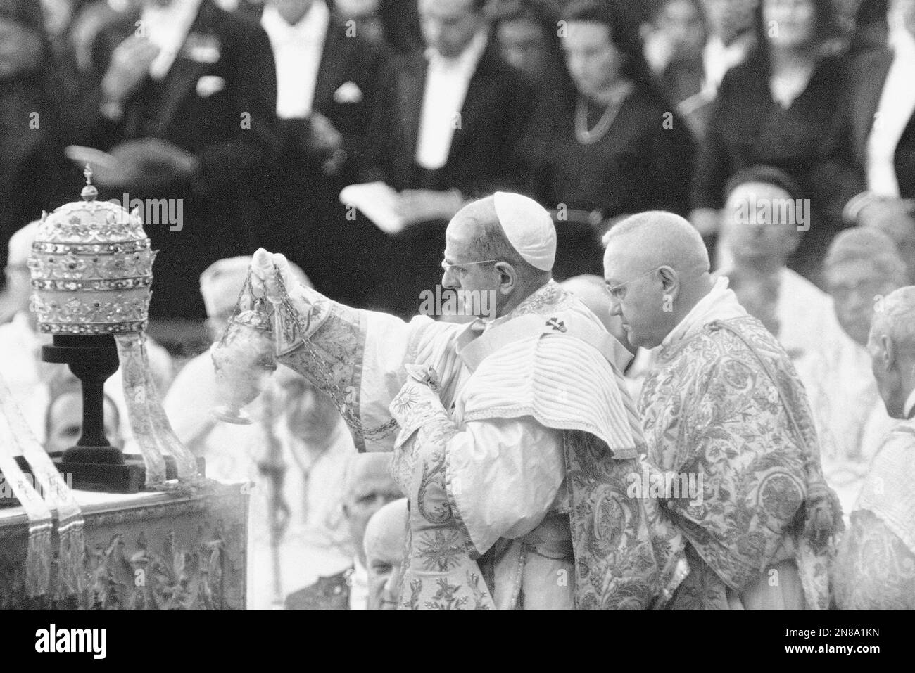Pope Paul VI wafts incense over his bee-shaped crown outside St. Peter ...
