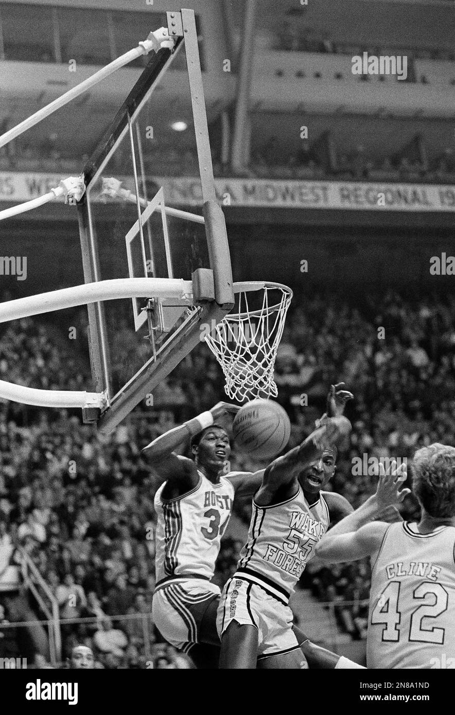 University of Houston's Akeem Abdul Olajuwon (34) slaps the basketball ...