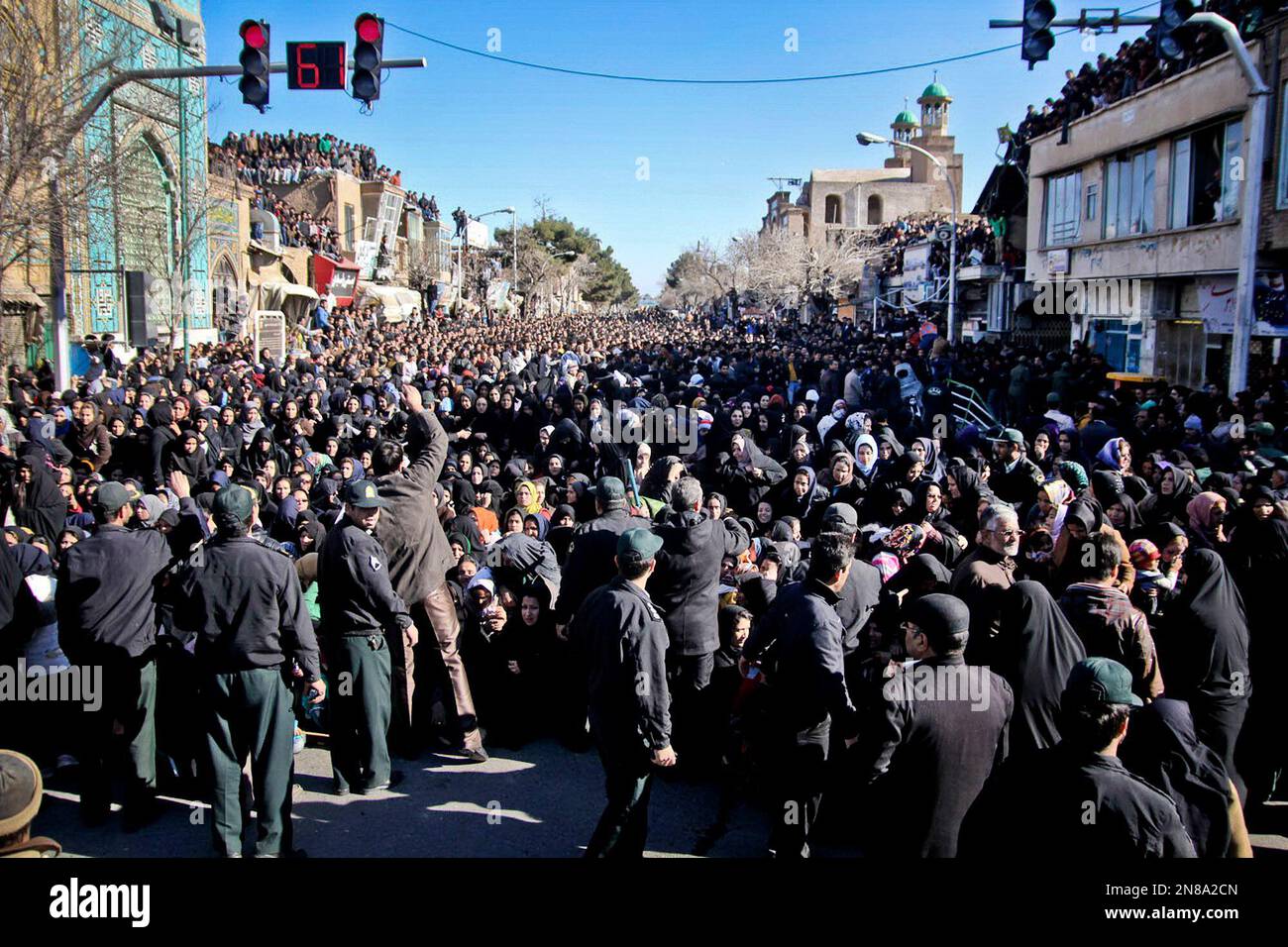 Iranians gather to watch officers lash two men, unseen, who are ...