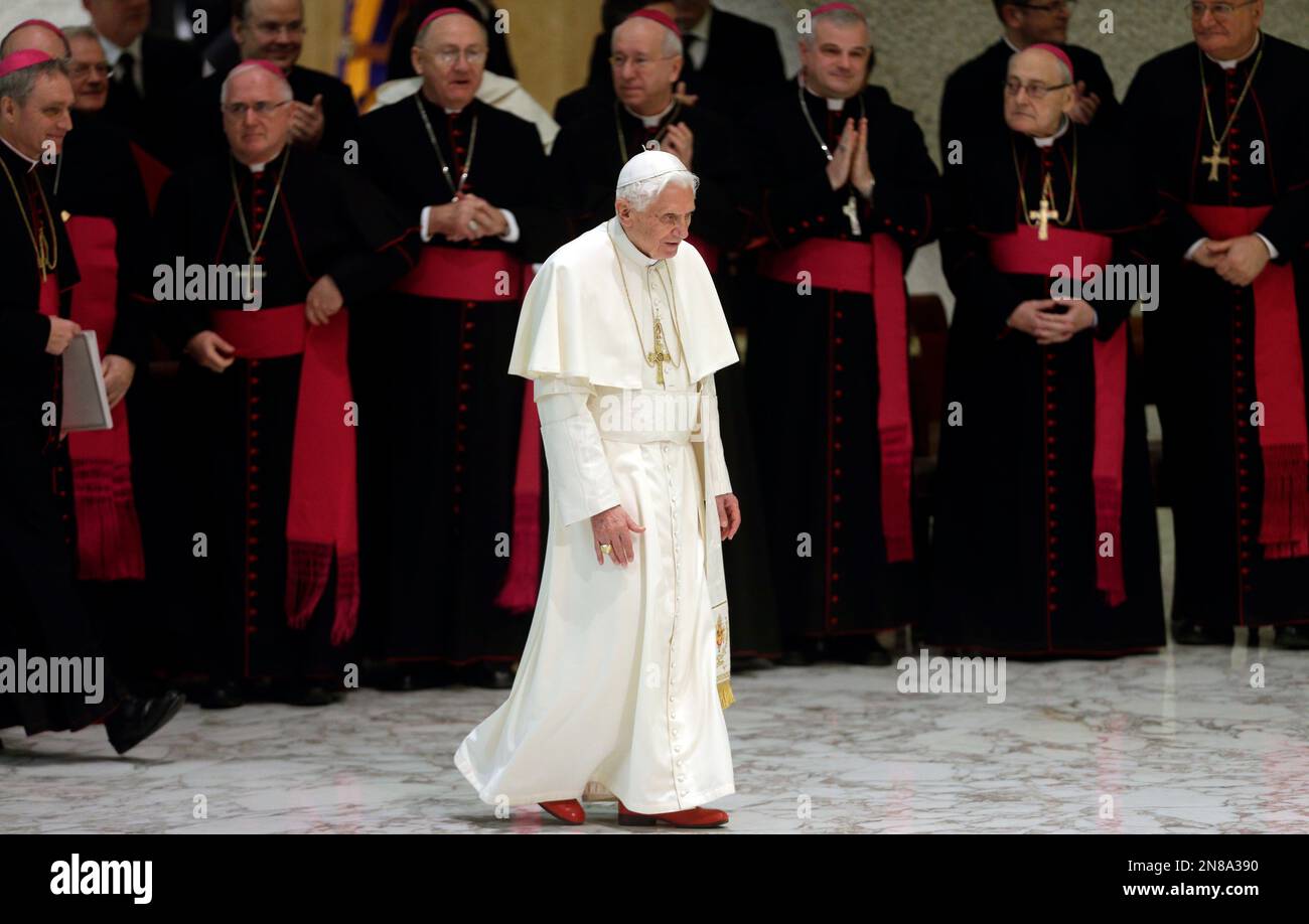 Pope Benedict XVI walks past prelates as he arrives for his weekly ...