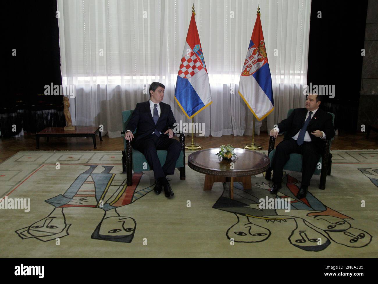 Serbian Prime Minister Ivica Dacic, right, speaks with his Croatian ...