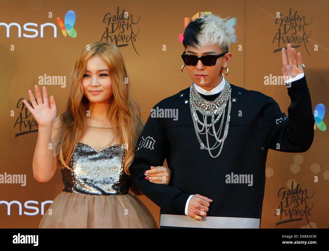 South Korean singers Lee Hi, left, and G-Dragon pose for photographers as they arrive on the red ...