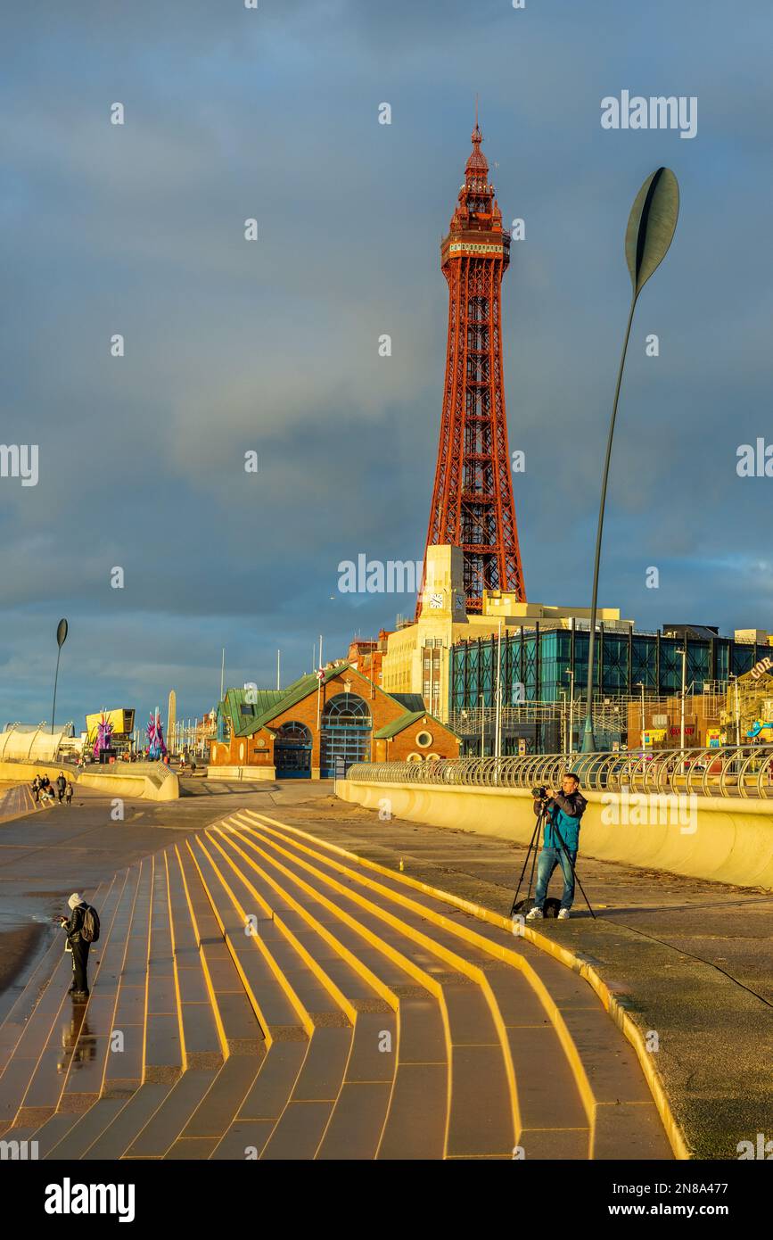 Blackpool Tower with man taking photo of pier Stock Photo - Alamy