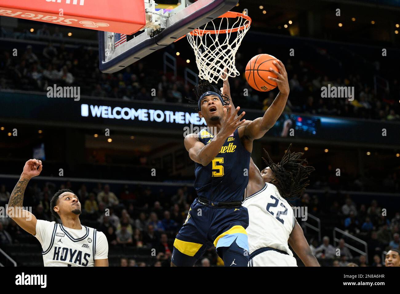 Marquette guard Chase Ross (5) goes to the basket over Georgetown ...