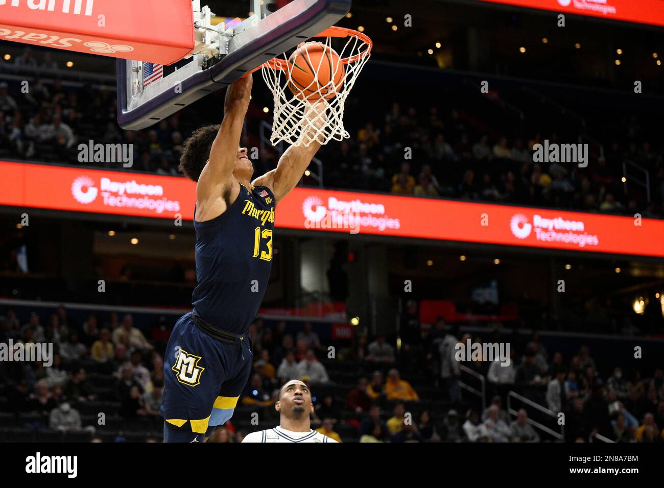 Marquette forward Oso Ighodaro (13) dunks over Georgetown guard Brandon ...