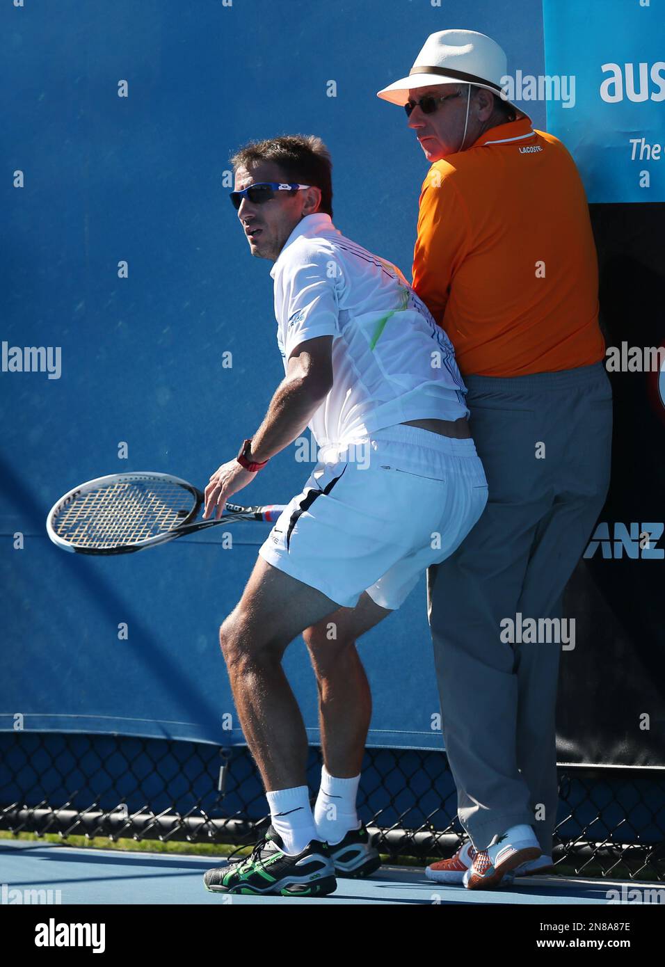 Spain's Tommy Robredo collides with a line umpire during his first ...