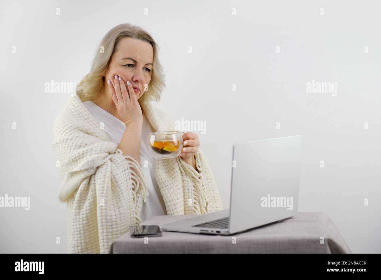 sensitive teeth to hot and cold looking at the screen monitor holding ...