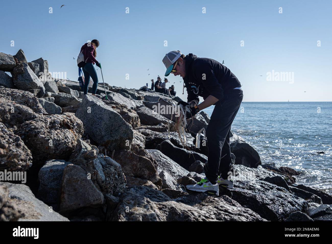 Barcelona, Spain. 11th Feb, 2023. A couple of volunteers pick up ...