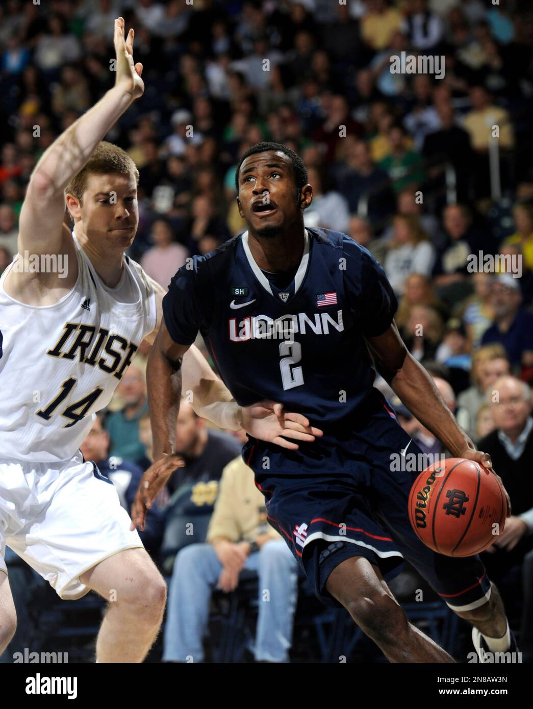 Connecticut forward DeAndre Daniels, right, drives the baseline as ...