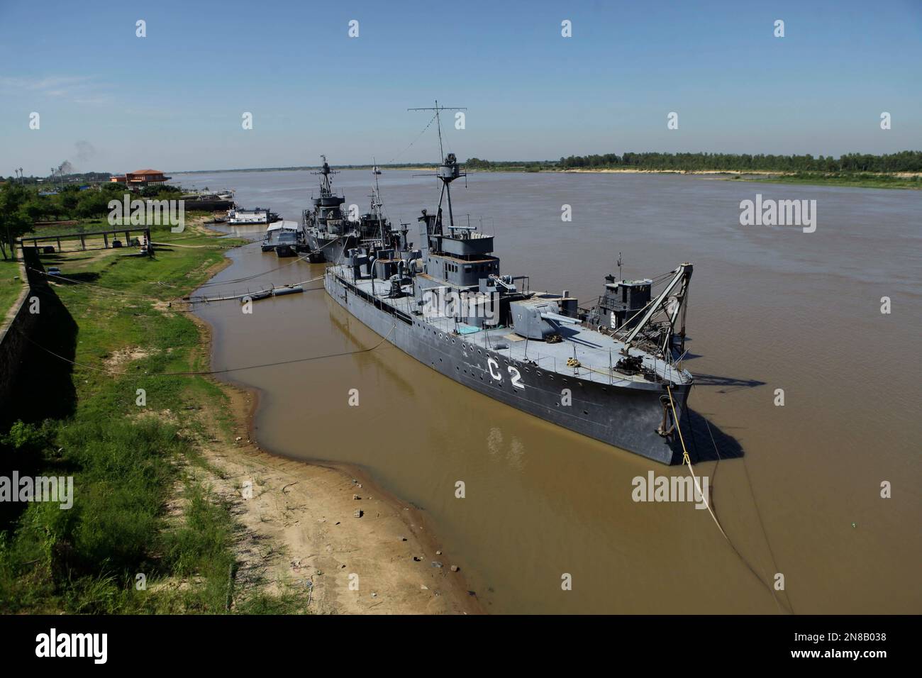 Navy ships sit anchored at the Sajonia Port in the Paraguay River near ...