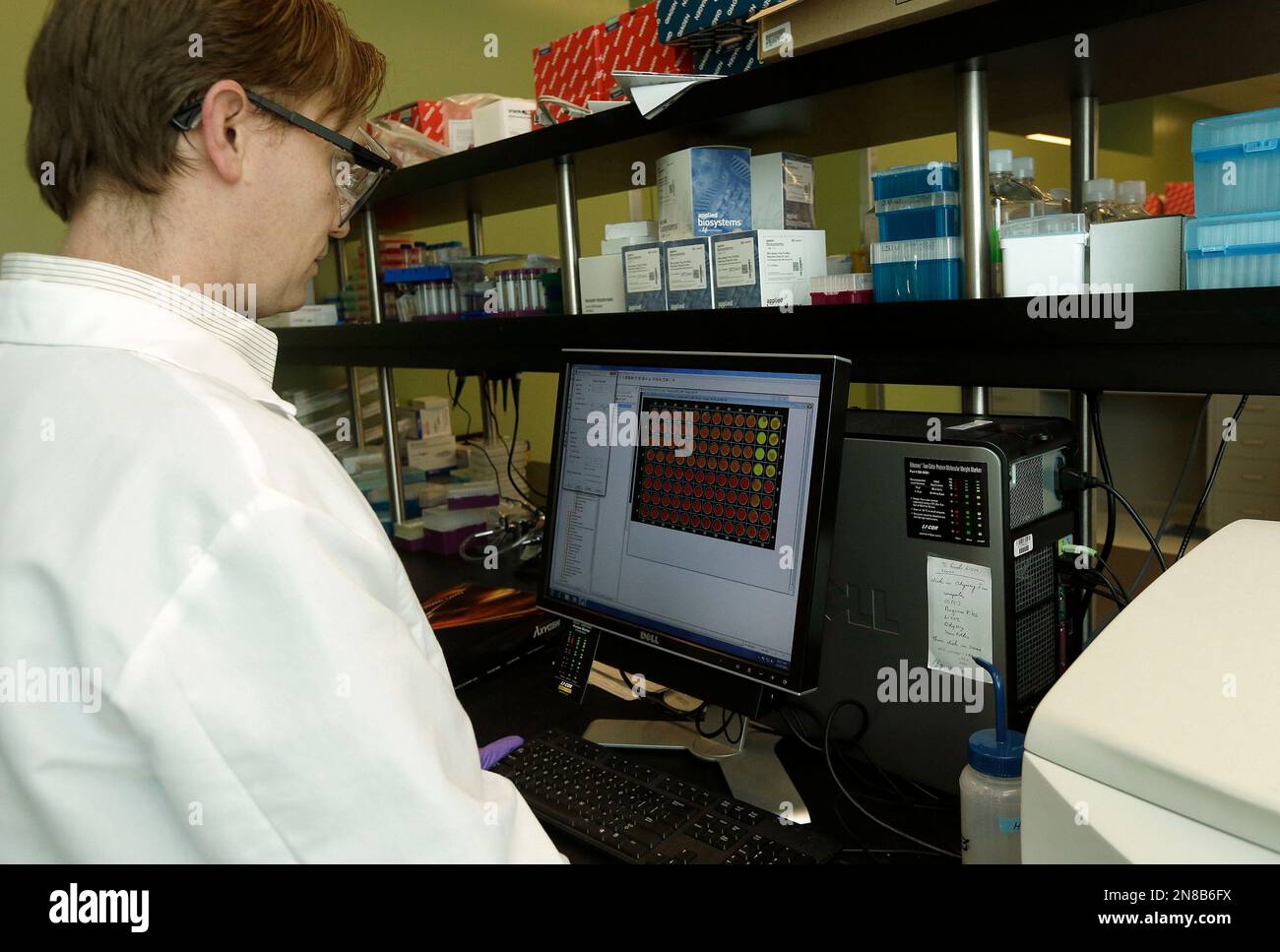 Principal scientist Charlie Holst demonstrates scanning cells on a 96 ...