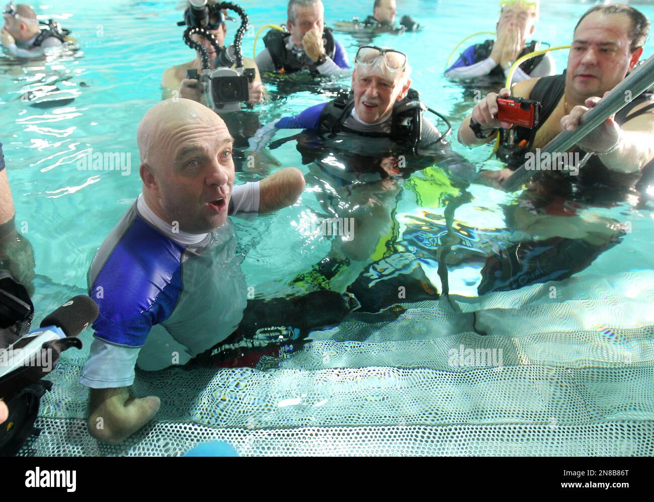 Limbless Philippe Croizon from France, left, celebrates, after he set a ...