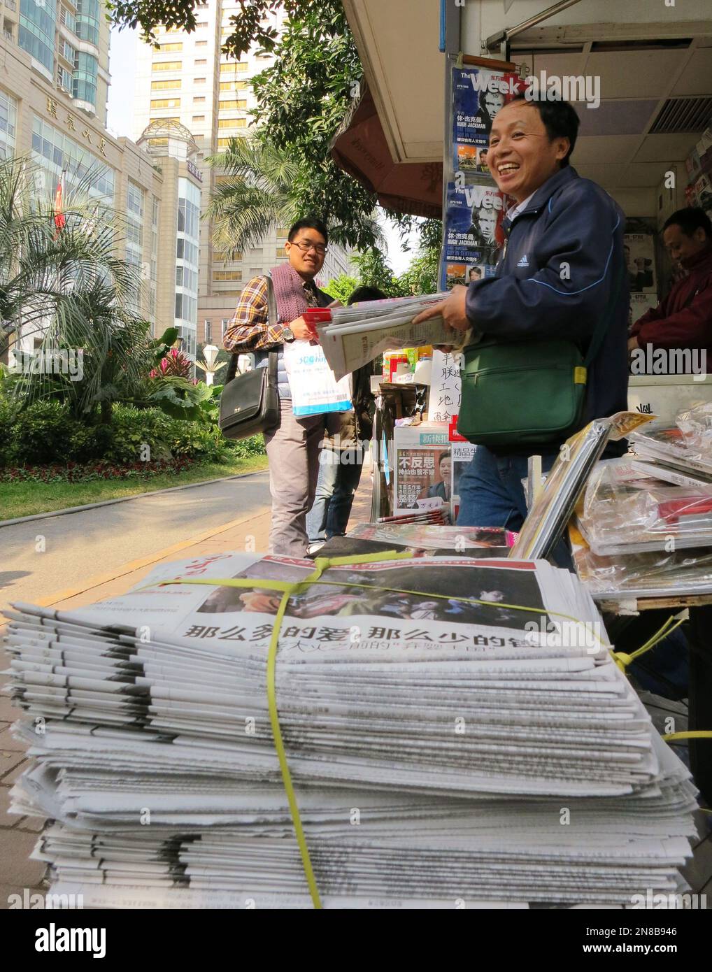 A delivery man holds a latest edition of Southern Weekly newspaper at a ...