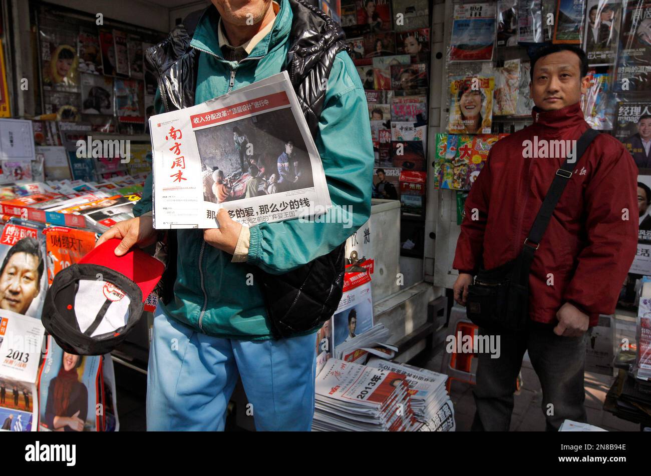A man displays a latest edition of Southern Weekly newspaper at a ...