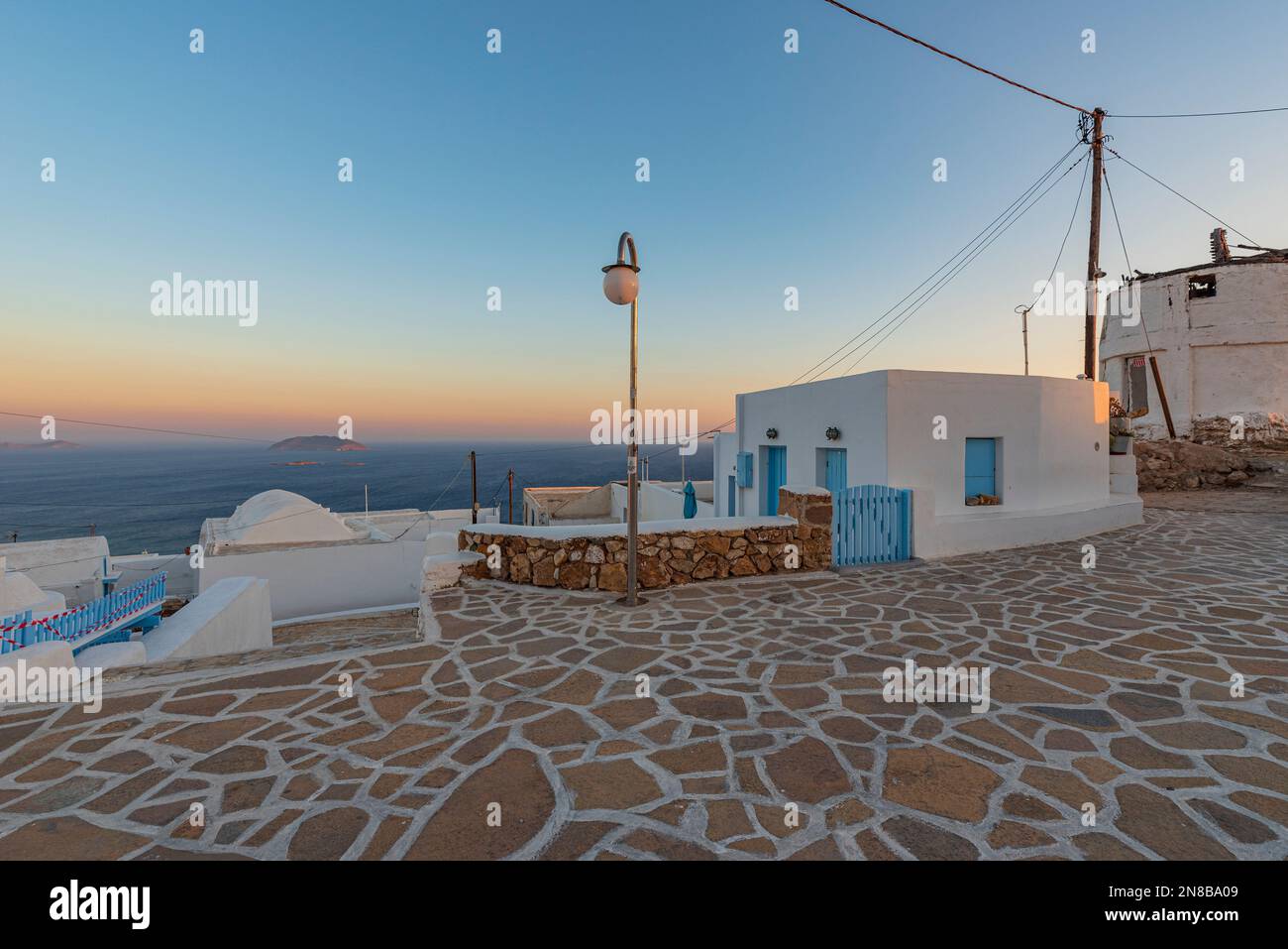 The sunset seen from the main square of Chora village, Anafi Stock ...