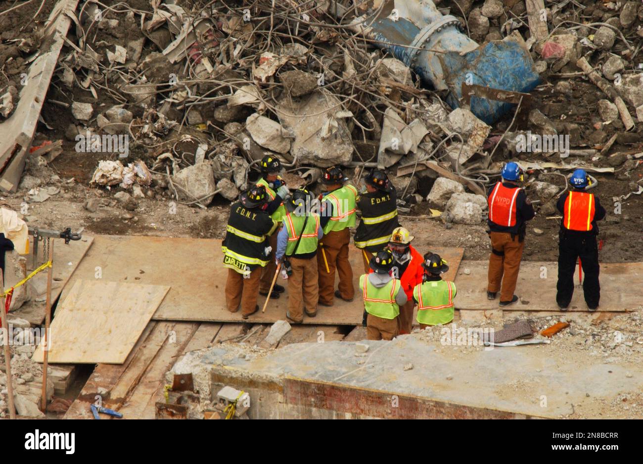 Firefighters look into the debris at ground zero as the search for victims' remains continues at ...