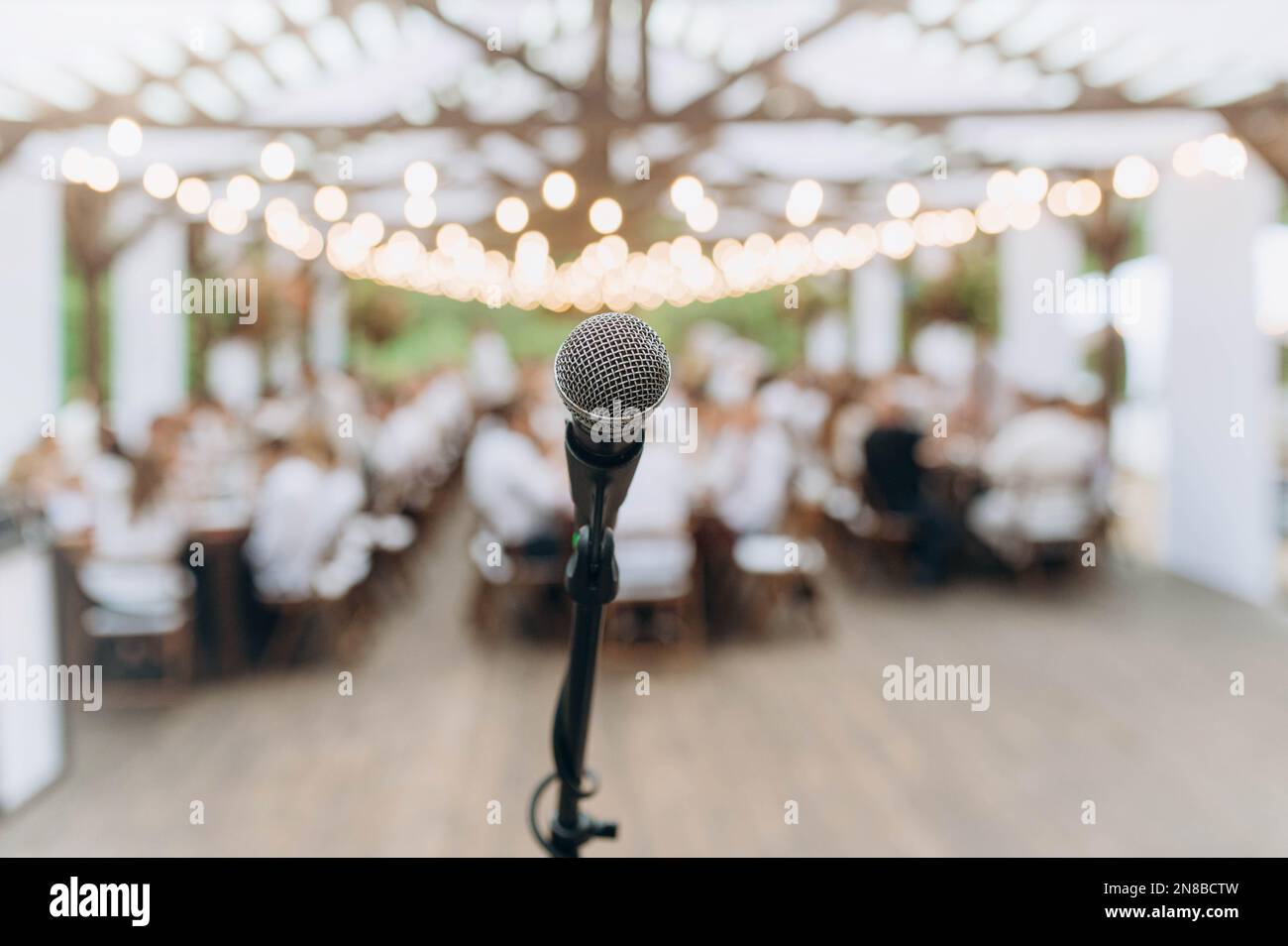 Microphone close-up. Focus on mic. Abstract blurred conference hall or ...
