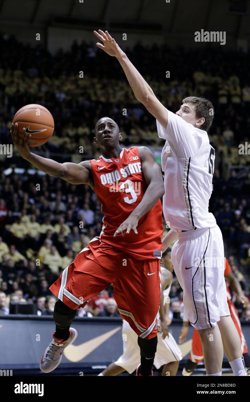Ohio State guard Shannon Scott, left, shoots under Purdue forward ...