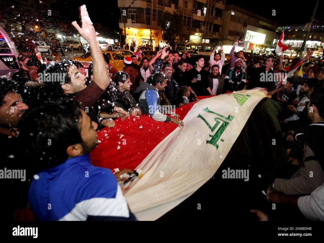 Iraqi soccer fans wave national flags as they celebrate Iraq's win over ...