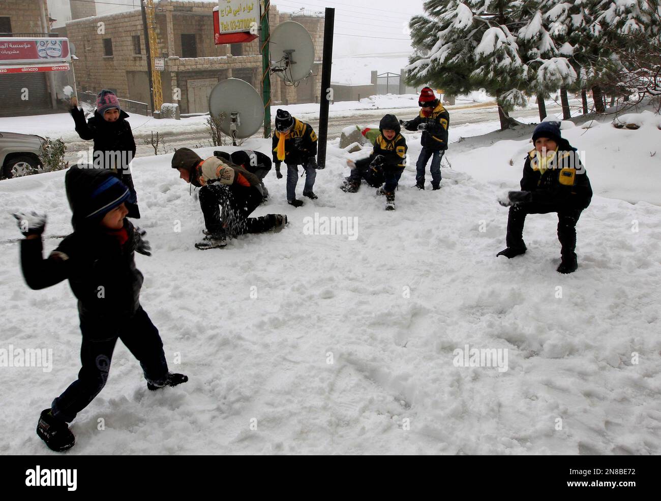 Syrian refugee children have a snowball fight at the mountain town of ...