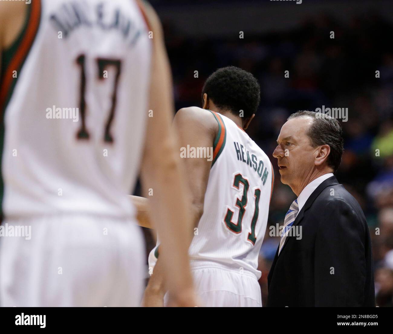 Milwaukee Bucks coach Jim Boylan, right, talks with John Henson (31 ...