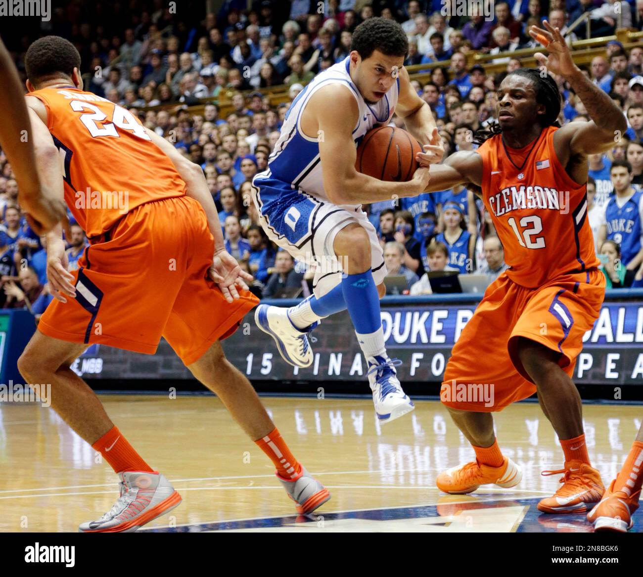 Duke's Seth Curry, center, drives between Clemson's Milton Jennings (24 ...
