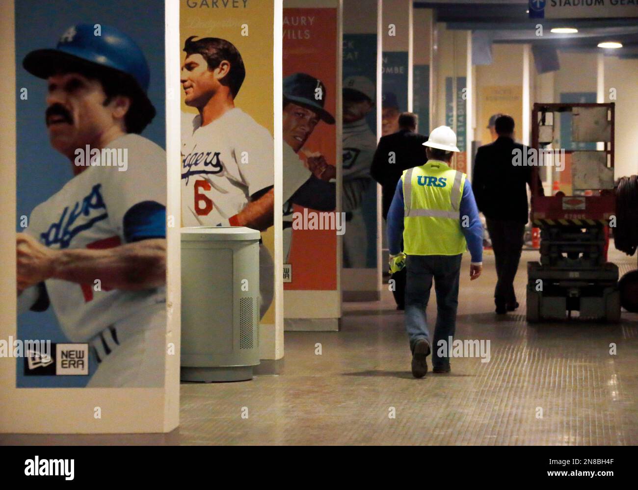 A construction worker walks down the Club Level concourse as work ...