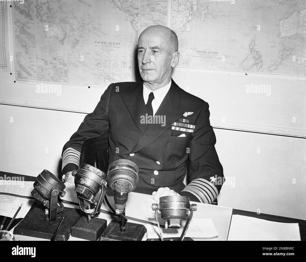 Admiral Ernest J. King, commander-in-chief of the U.S. fleet, is shown in his Navy Dept. office ...