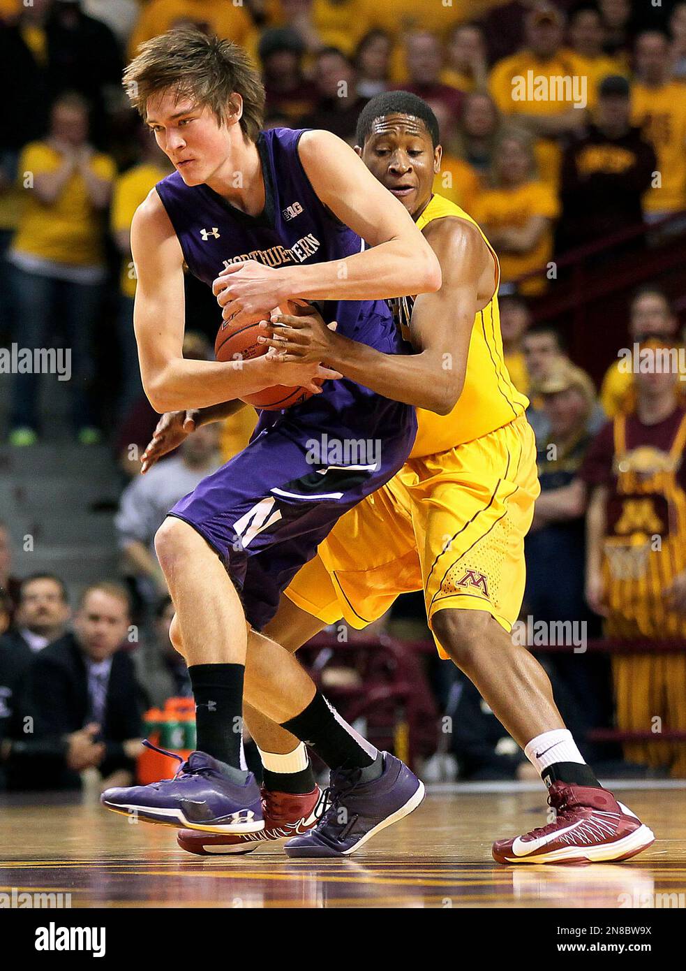 Northwestern forward Kale Abrahamson, right, is pressured Minnesota ...