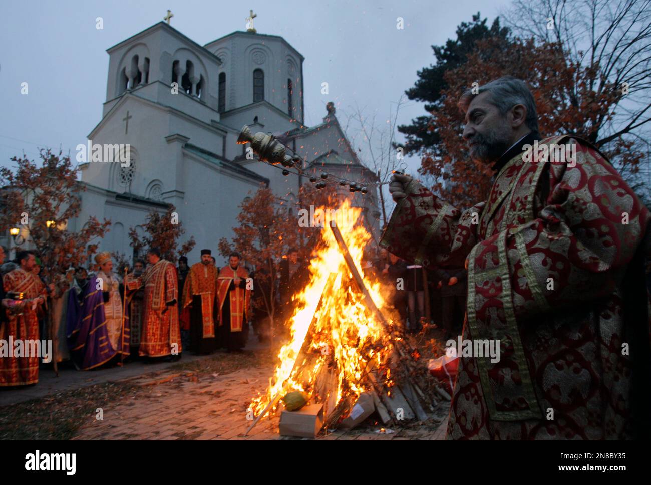 Serbian Orthodox Church priest performs during a ceremonial burning of ...