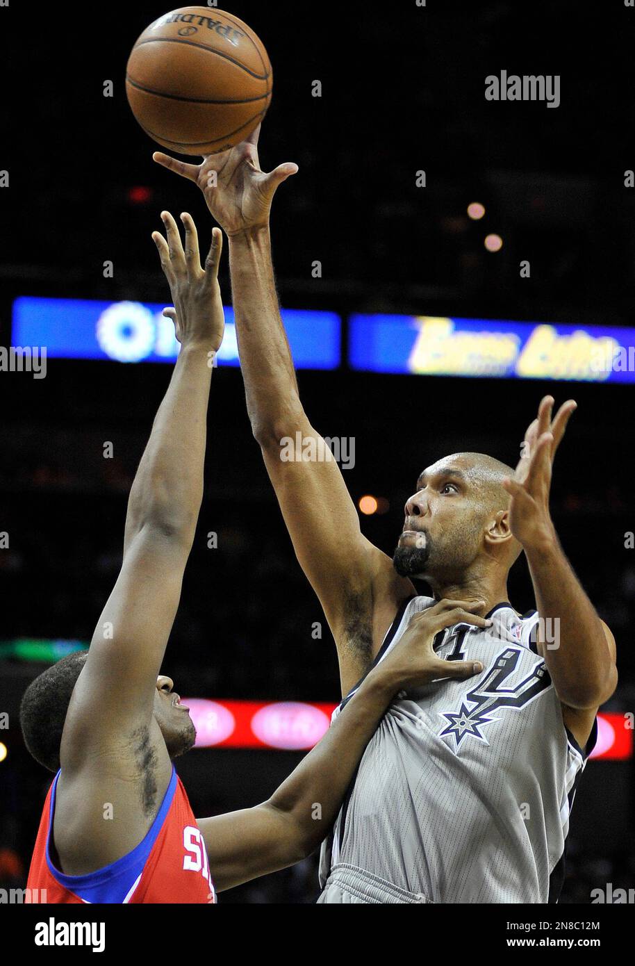 San Antonio Spurs' Tim Duncan, right, shoots over Philadelphia 76ers ...