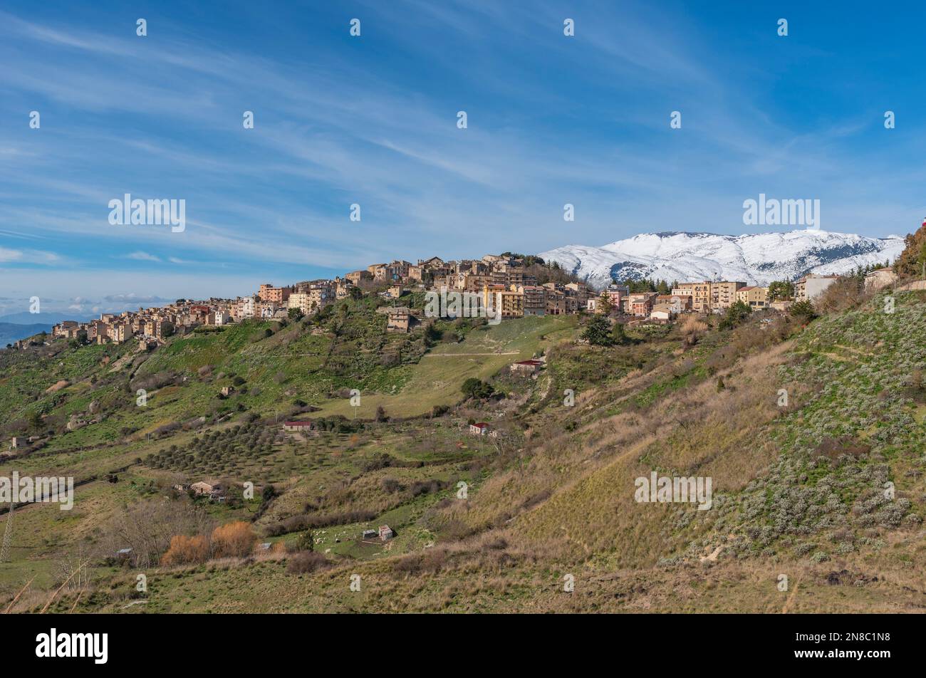 View of Polizzi Generosa village among the snow-capped peaks of the ...