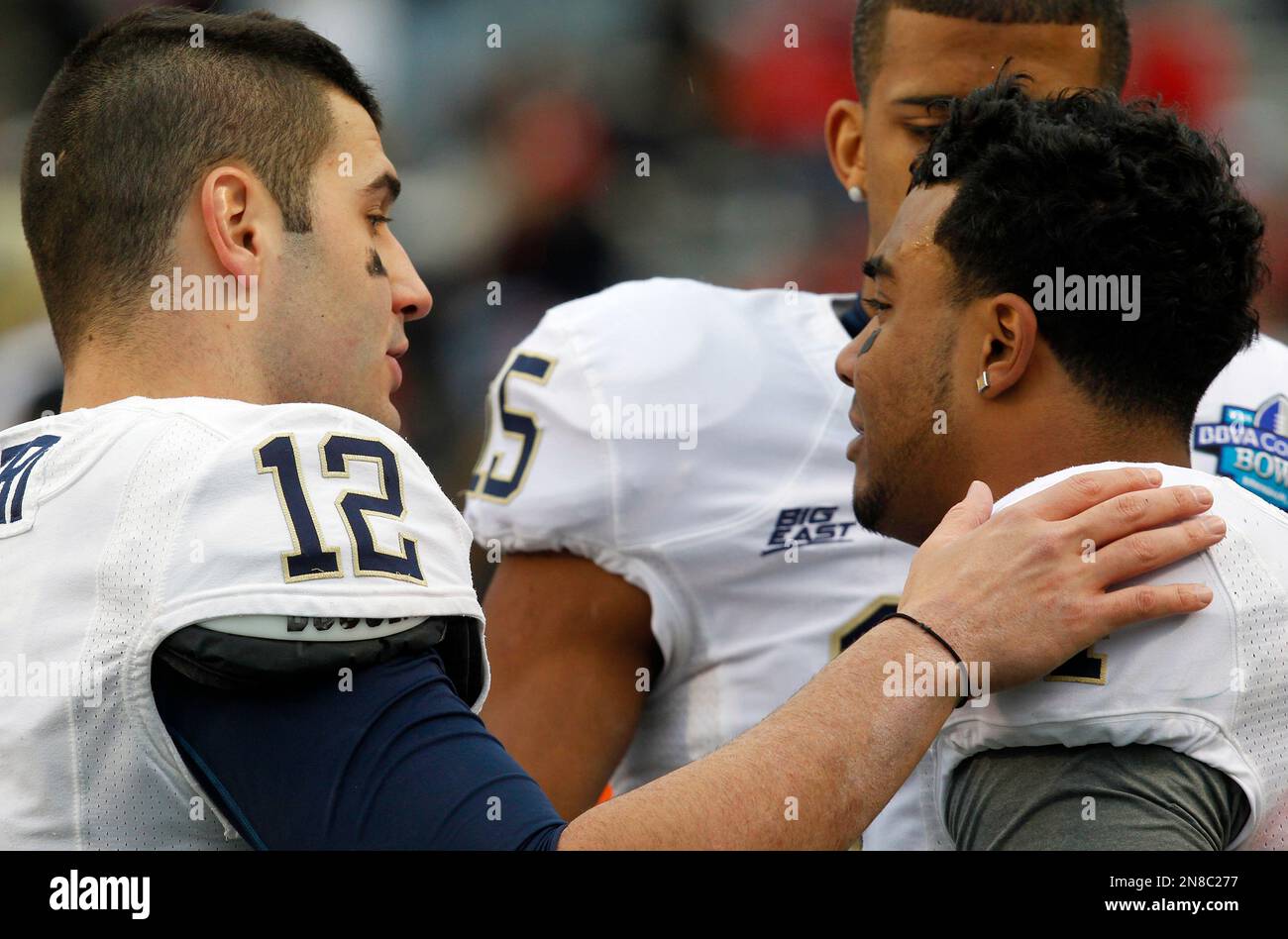 Pittsburgh quarterback Tino Sunseri (12) tries to console running back ...