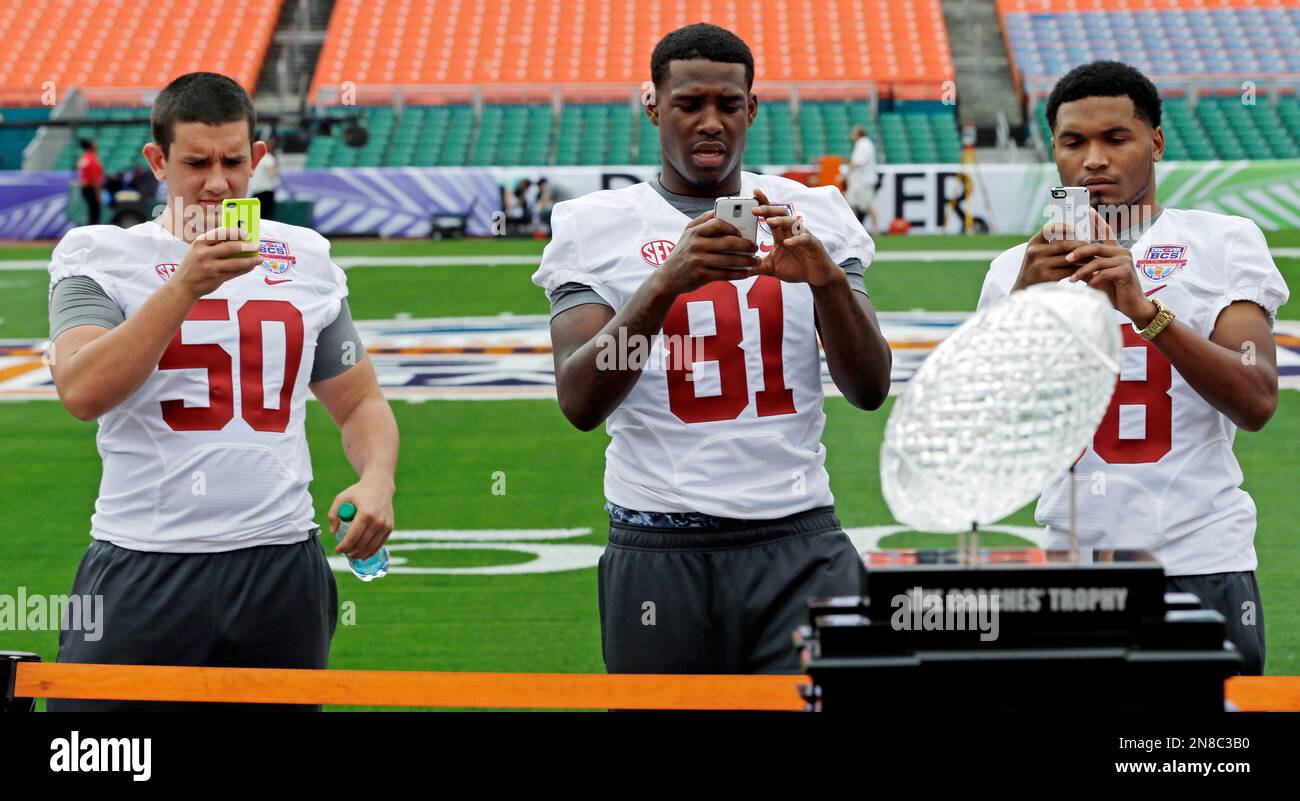 Alabama's Alphonse Taylor (50), Danny Woodson (81) and Josh Magee take ...