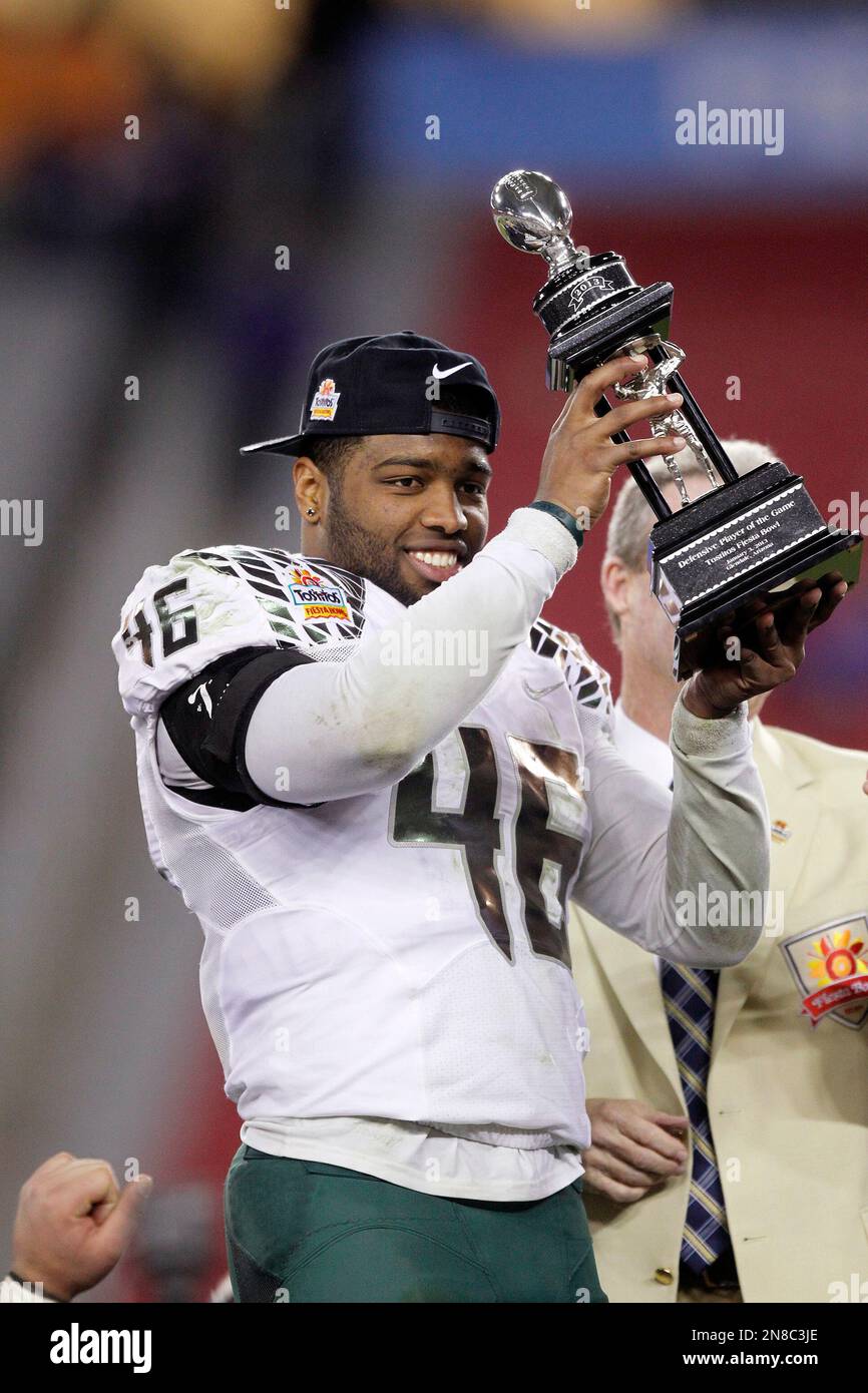 Oregon's Michael Clay accepts the defensive player of the game trophy ...