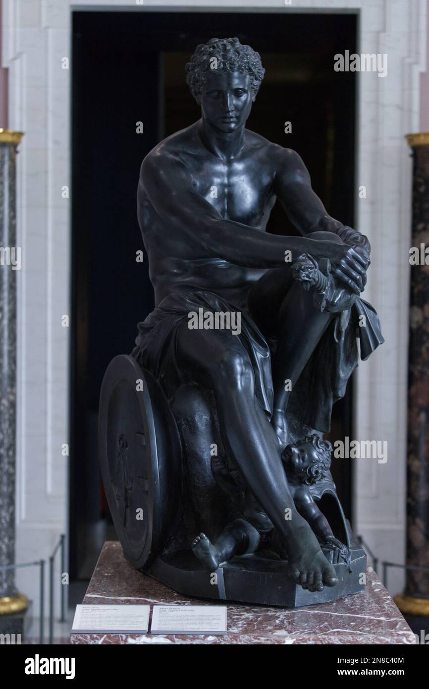 A vertical shot of the Mars Seated sculpture in the Louvre, Paris ...
