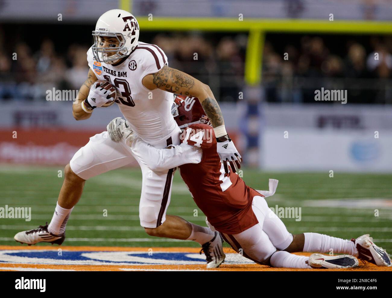 Oklahoma's Durron Neal (13) drags Oklahoma defensive back Aaron Colvin ...