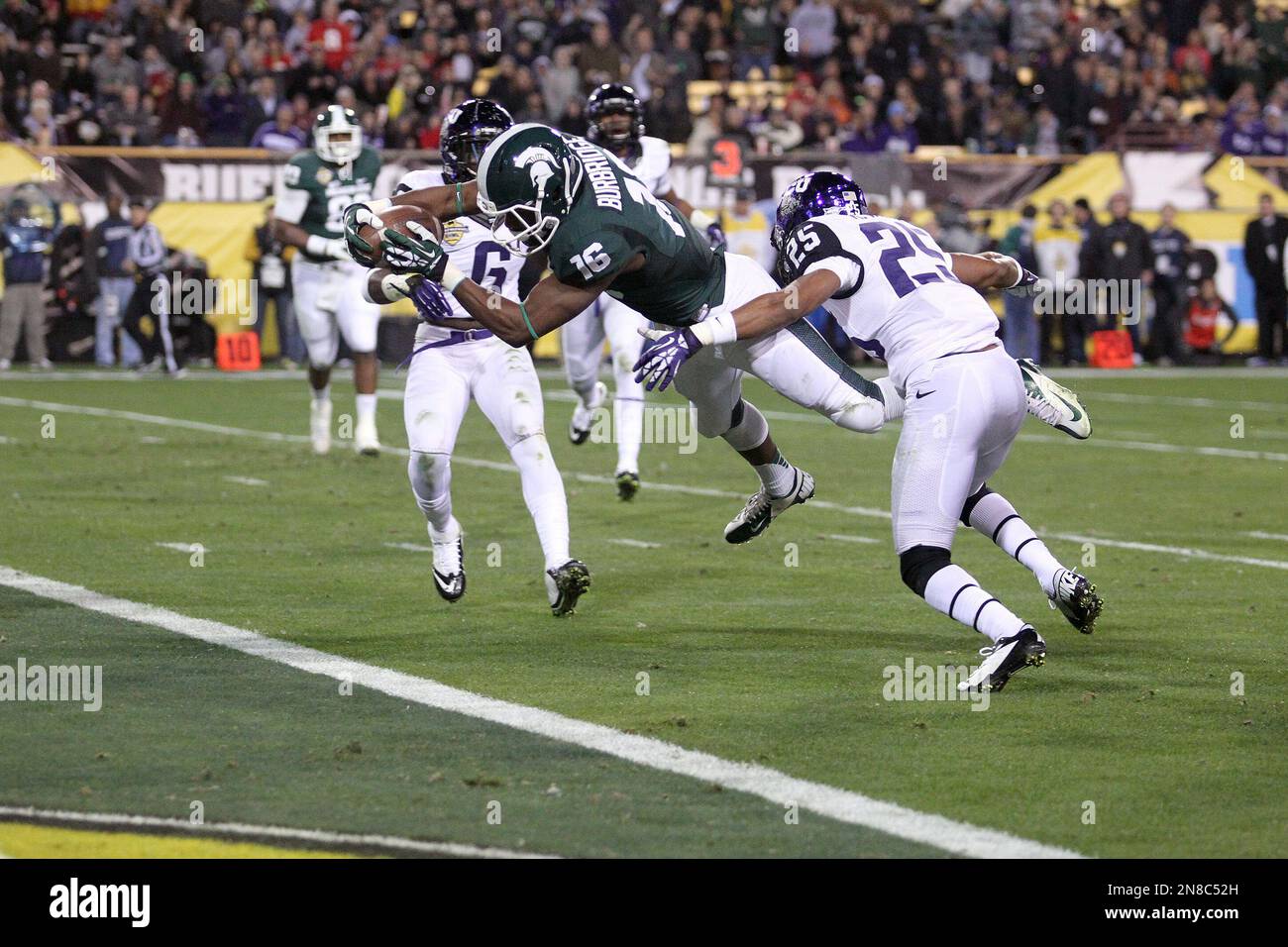 Michigan State's Aaron Burbridge, center, against TCU's Elisha Olabode ...