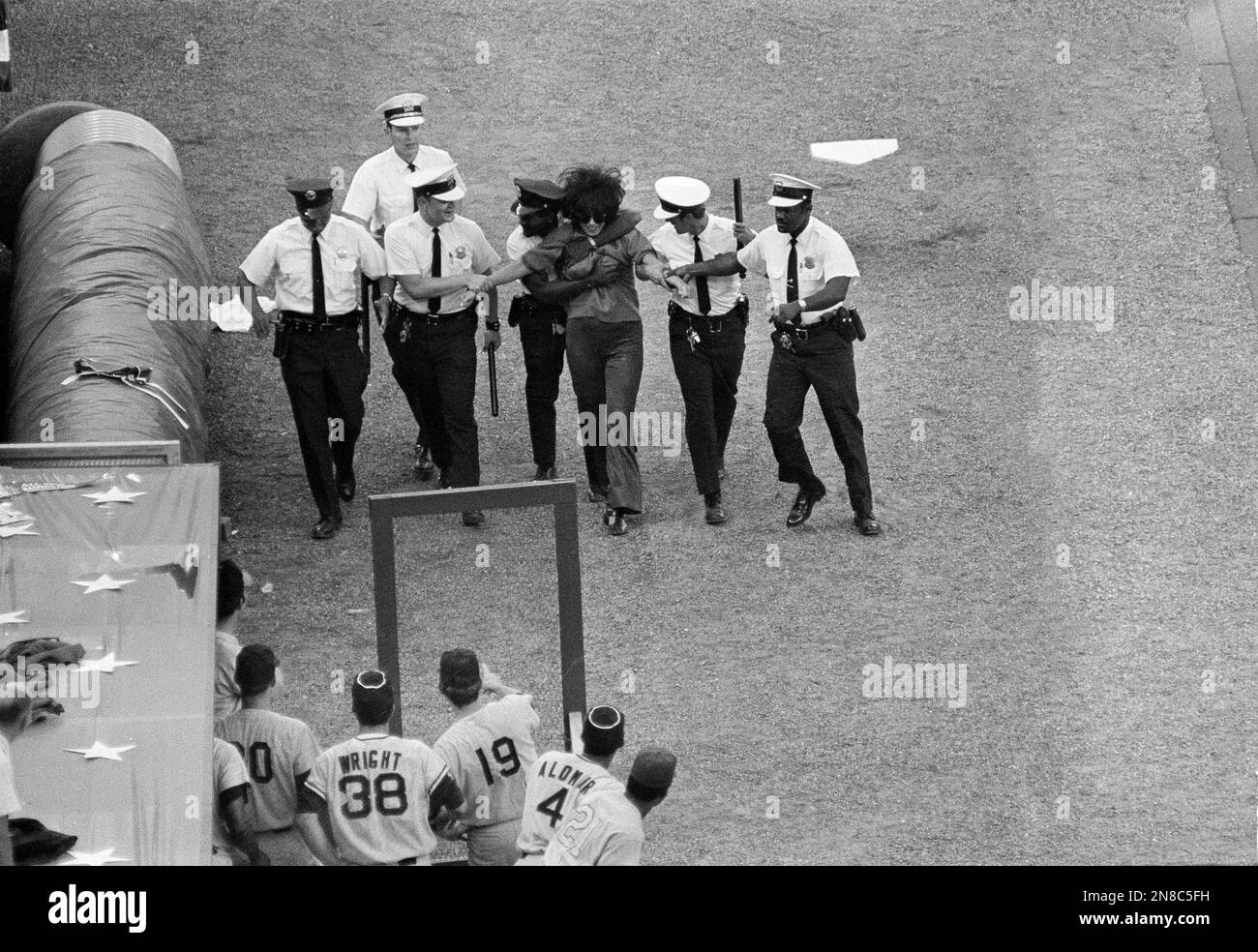 A women who says she is Morganna Roberts is led from the field during ...