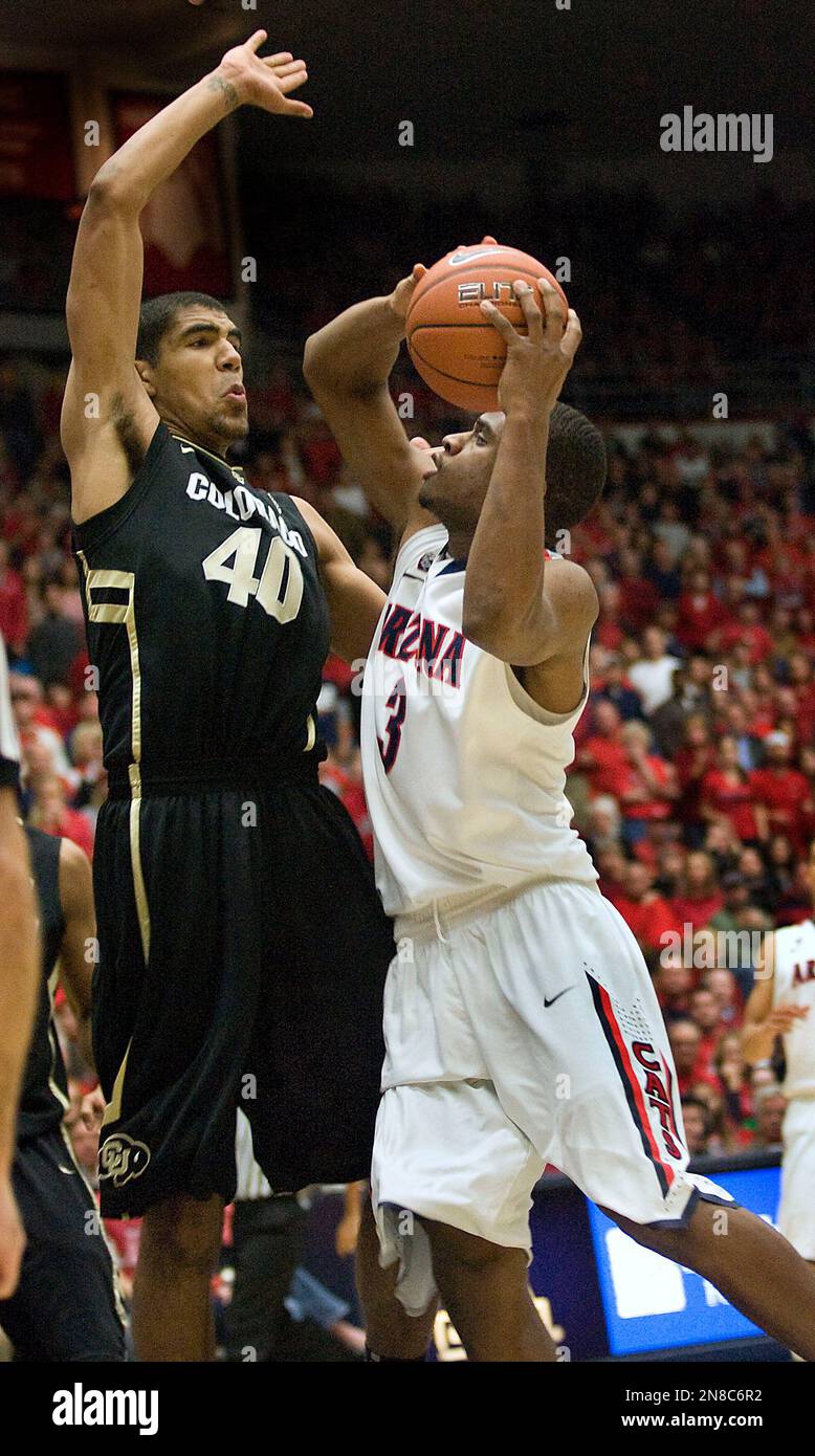 Arizona's Kevin Parrom (3) shoots over Colorado's Josh Scott (40)during ...