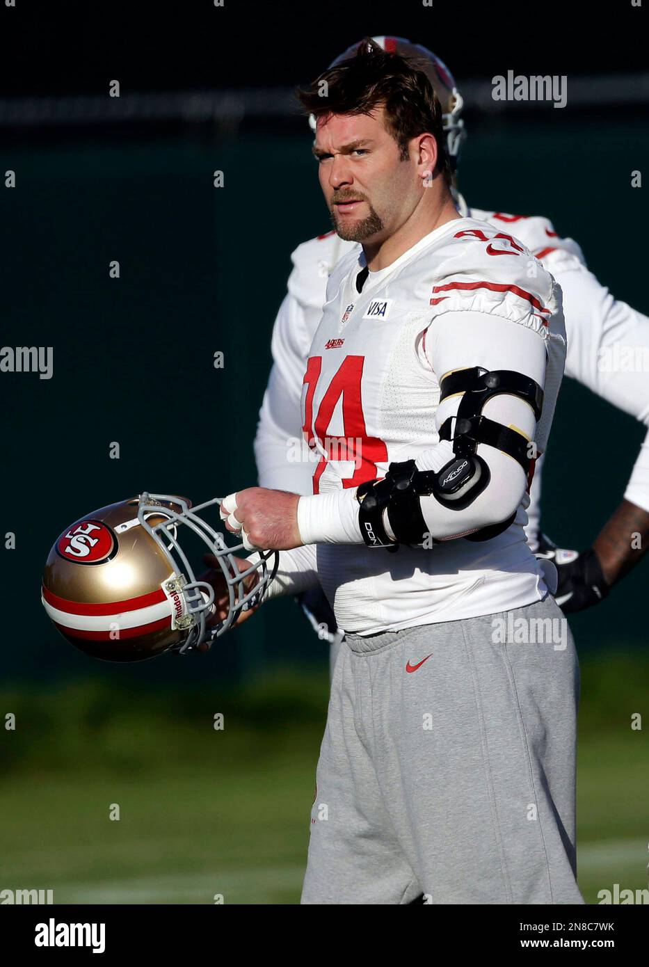 San Francisco 49ers defensive tackle Justin Smith wears a brace on his ...
