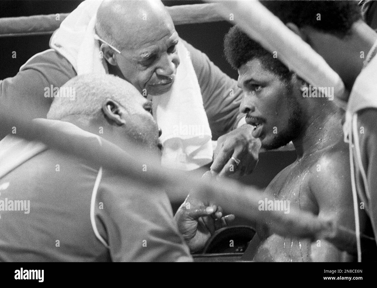 Leon Spinks is attended to by trainer Sam Solomon, lower left, and ...