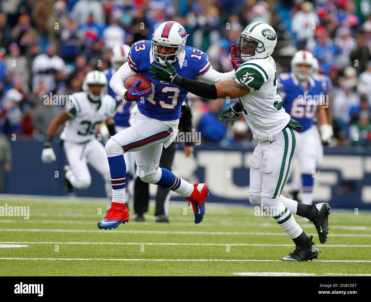 Buffalo Bills' Stevie Johnson (13) stiff arms New York Jets' Yeremiah ...