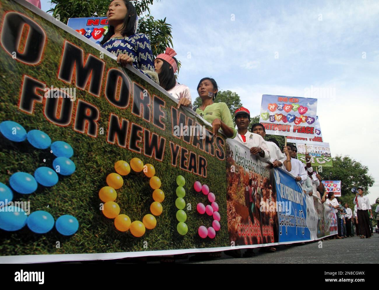 Activists march during a rally to end the fighting in northern Myanmar ...