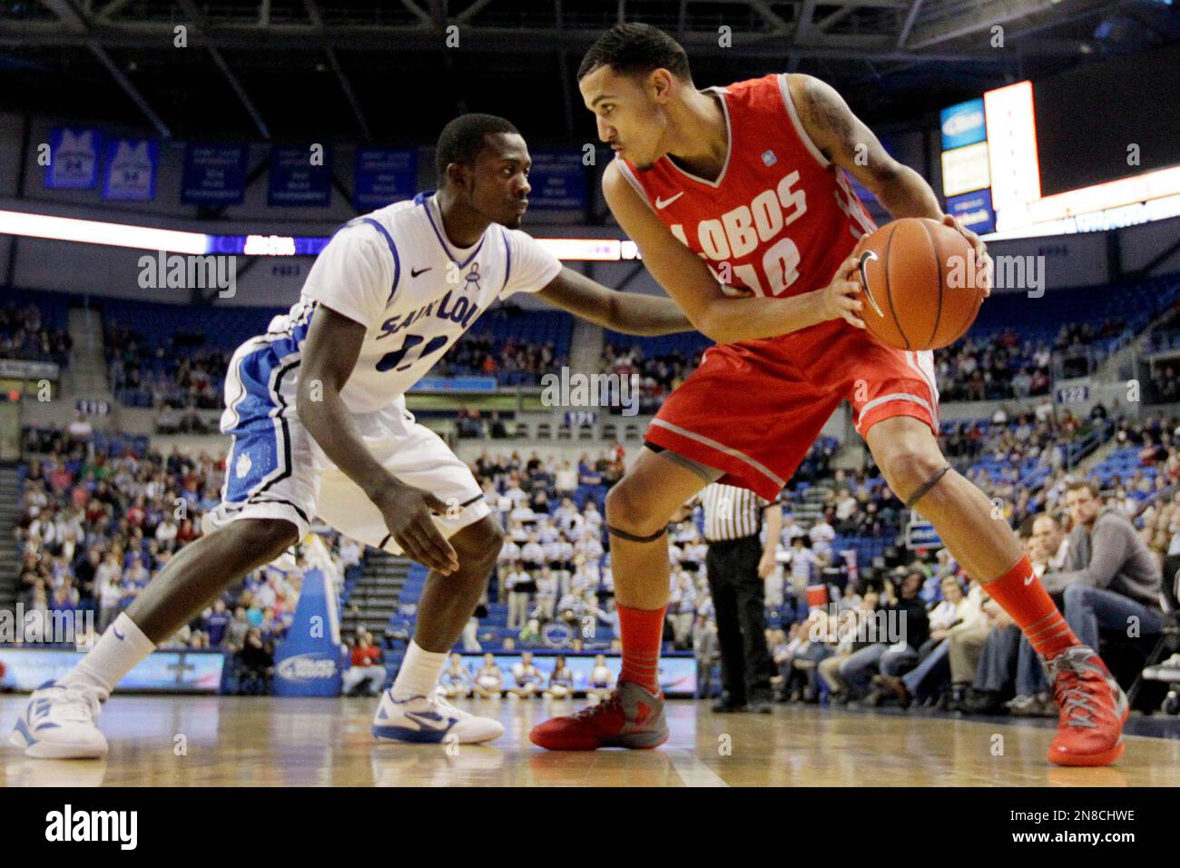New Mexico's Kendall Williams, right, looks to pass around Saint Louis ...