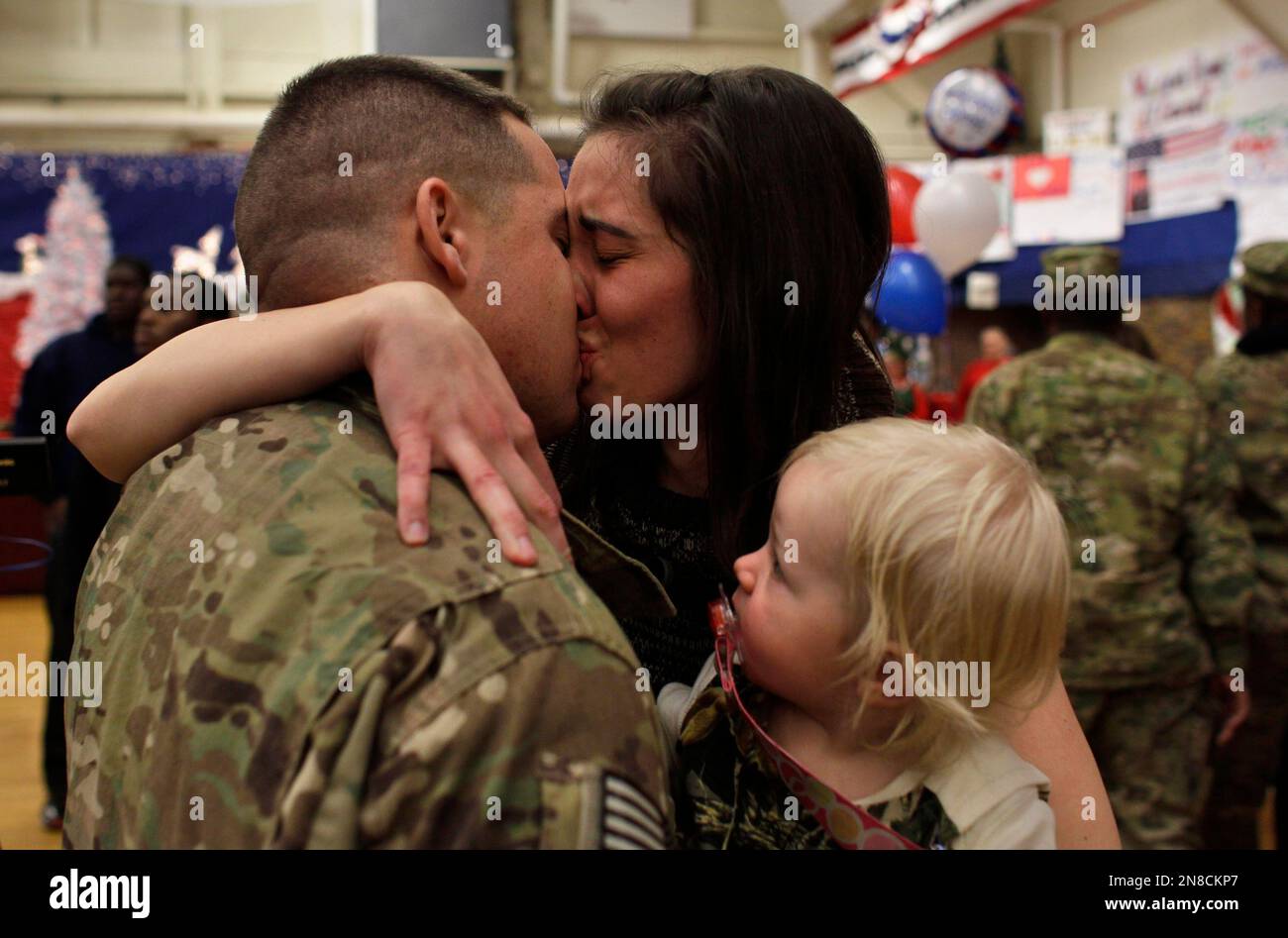 In this Nov. 30, 2012. photo, U.S. Army 1st Lt. Aaron Dunn kisses his ...