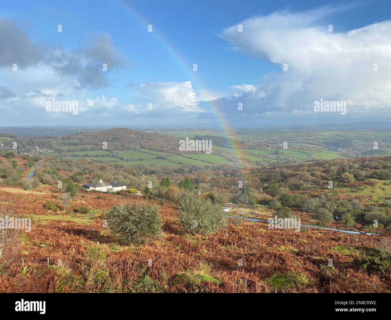 A scenic shot of the rainbow in a moorland under the blue sky, cool for ...