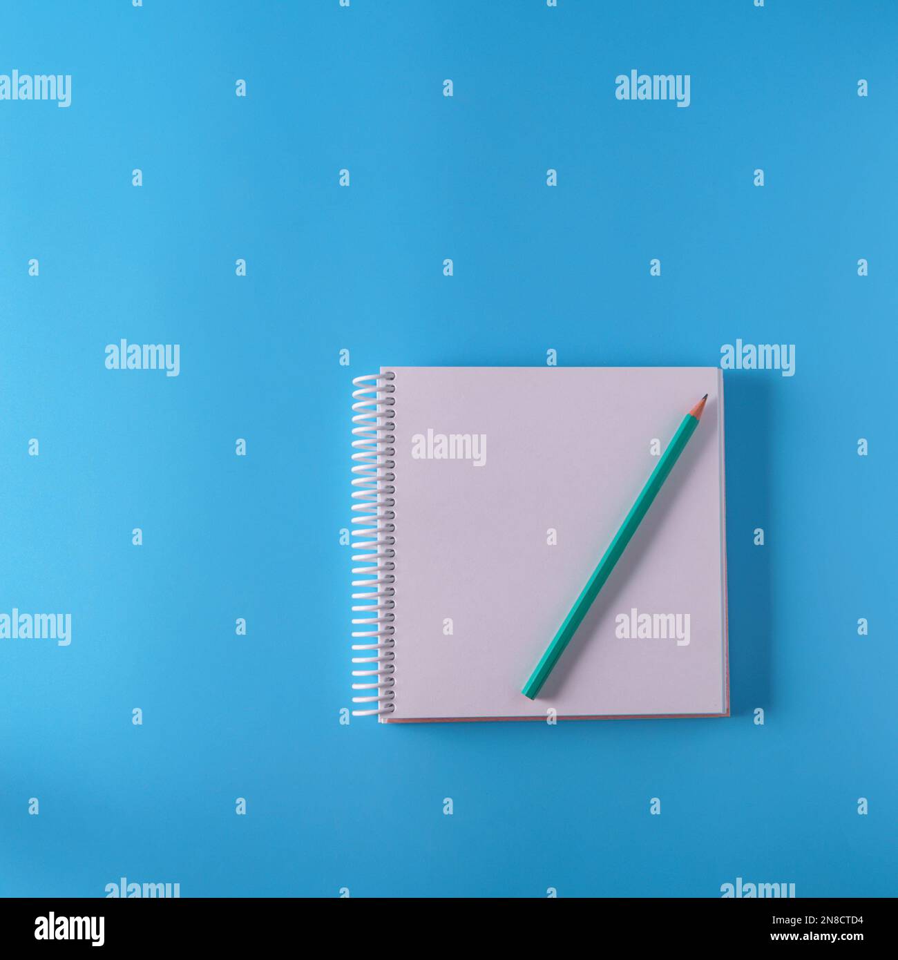 Mockup. An empty school notebook with a spiral spring in expanded form ...